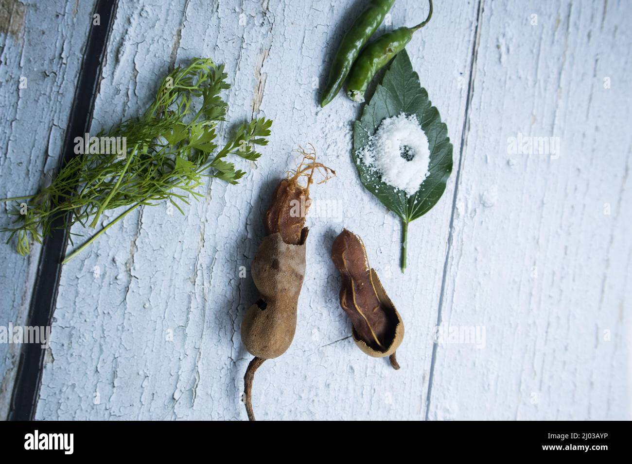 Some raw tamarind with tamarind leaf Stock Photo - Alamy
