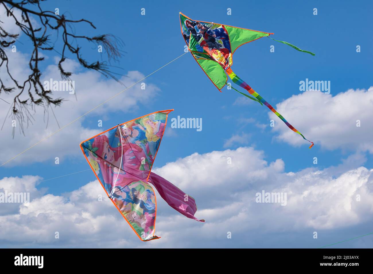 colorful kites in blue sky with small white clouds Stock Photo - Alamy