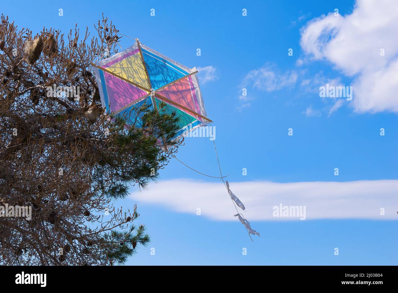 colorful kites in blue sky with small white clouds Stock Photo - Alamy