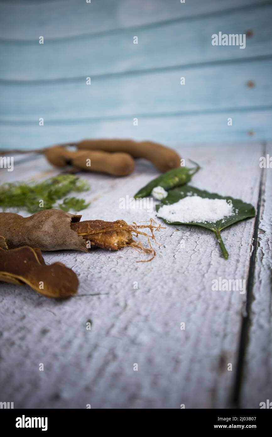 Some raw tamarind with tamarind leaf Stock Photo - Alamy