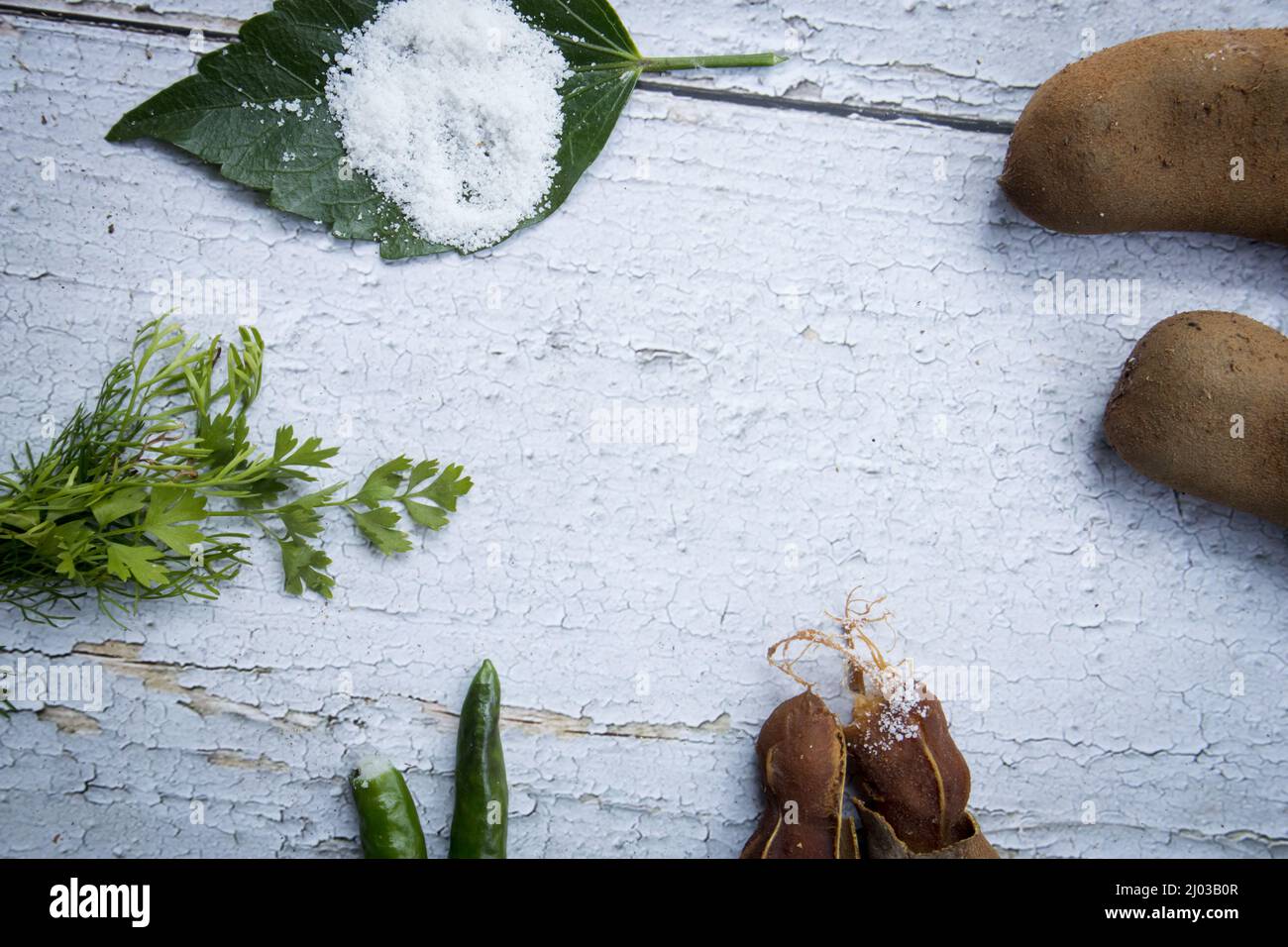 Some raw tamarind with tamarind leaf Stock Photo - Alamy