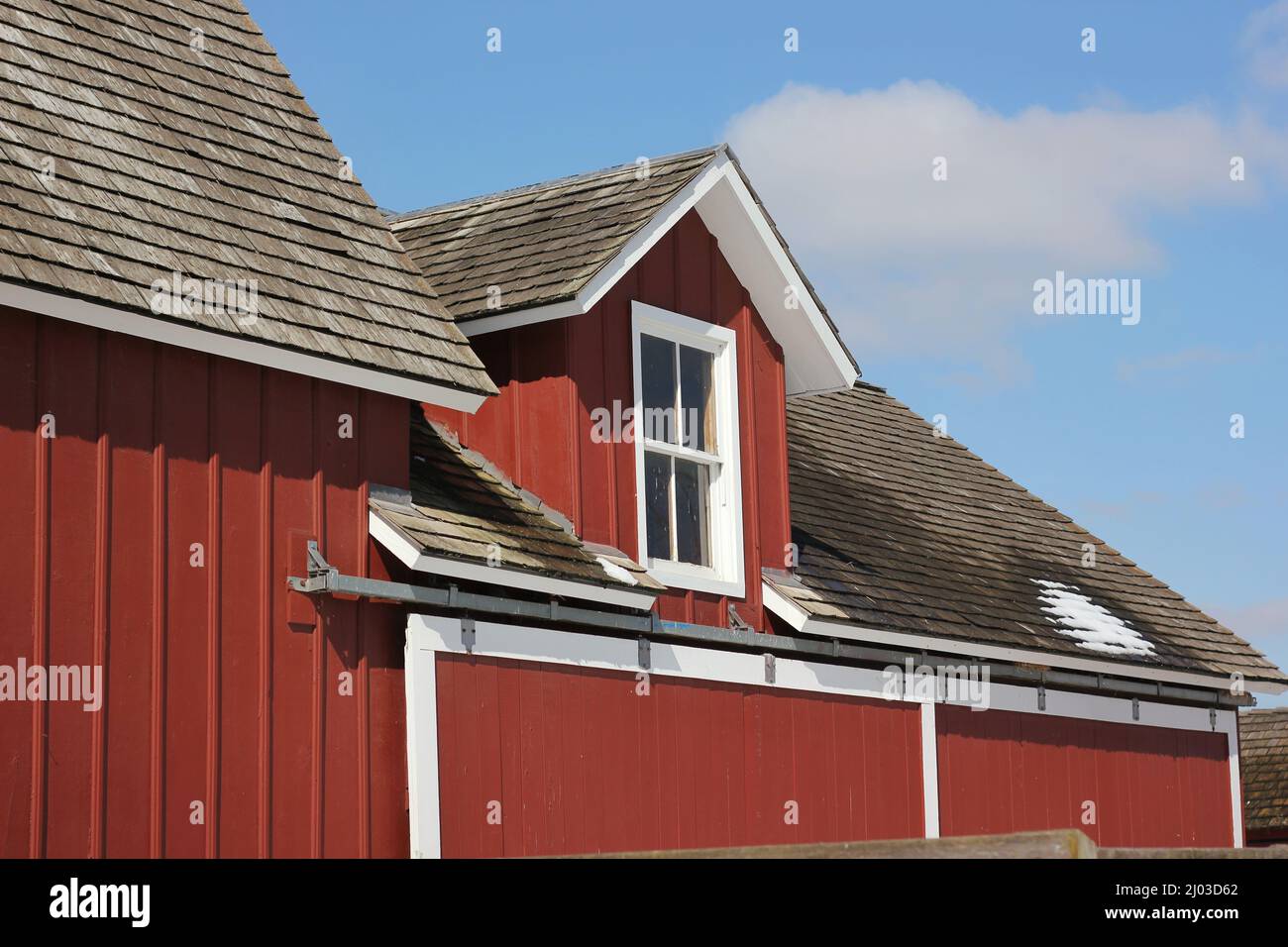 Traditional barn red window facing the bright sun Stock Photo - Alamy