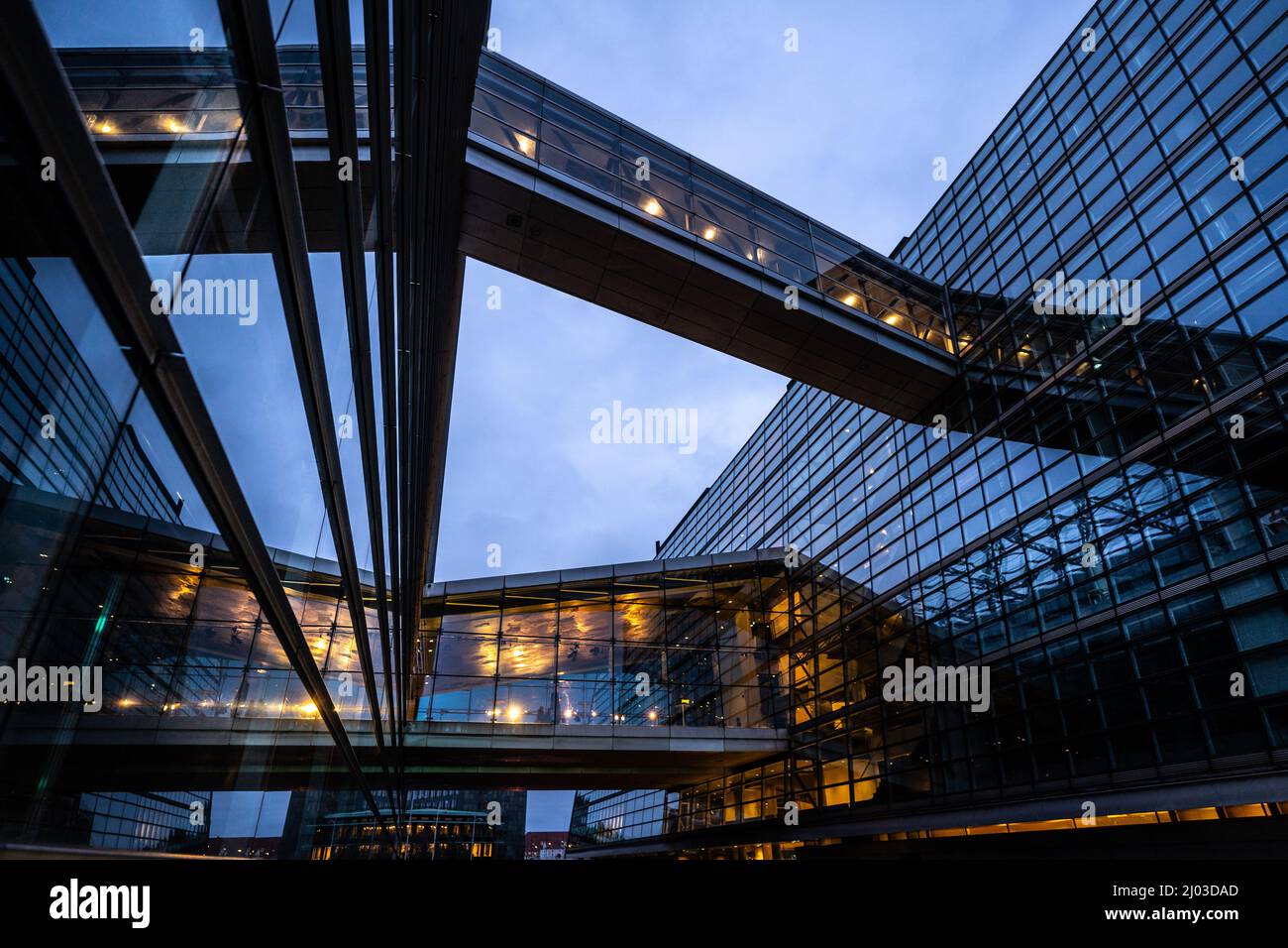 Shot of the traffic below the glass bridge on a modern building in ...