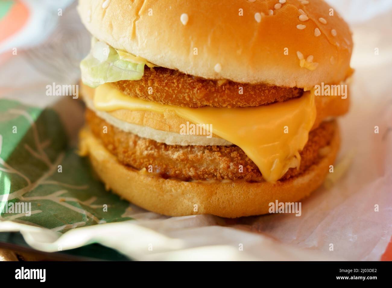 Cheeseburger with double cutlet close-up in a fast food restaurant ...