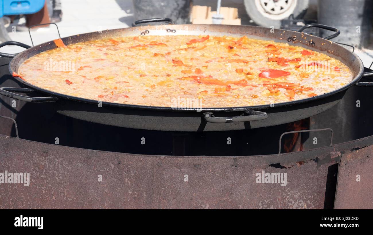 cooking big dish of paella open fire,Spain Stock Photo - Alamy