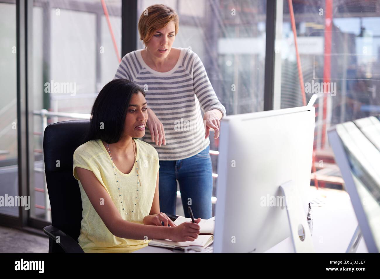 What if we put that there.... Portrait of two colleagues working ...