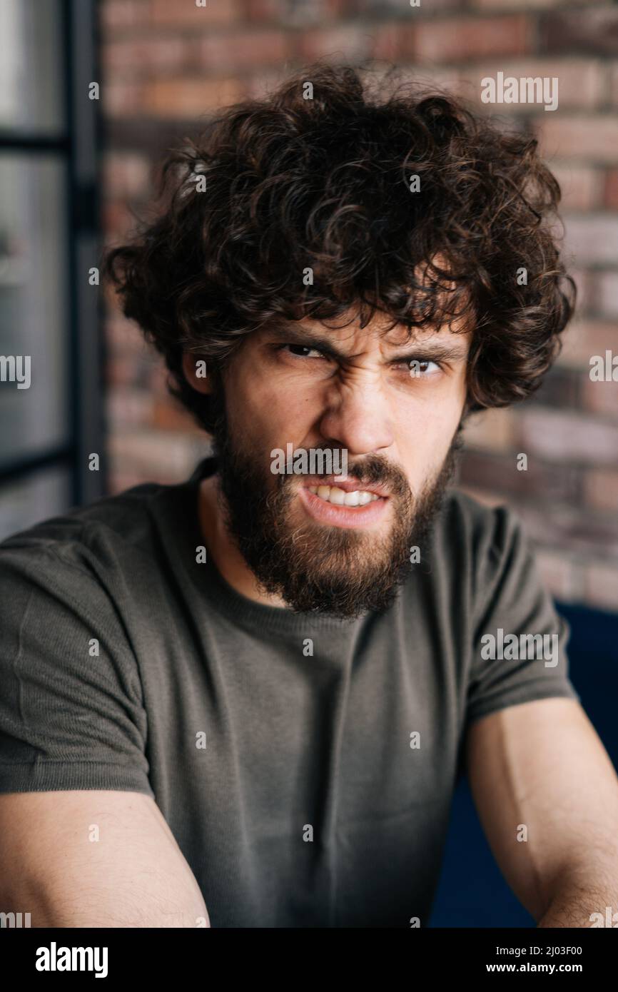 Close-up vertical portrait of friendly handsome young man looking at ...