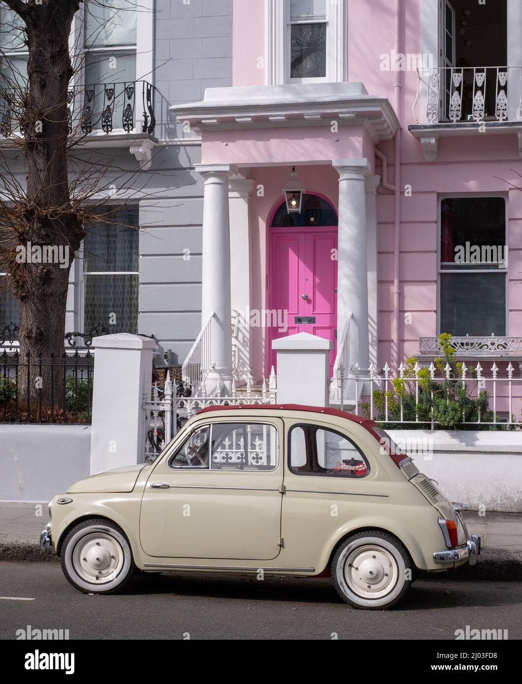 Beige coloured vintage Fiat 500 classic car parked in front of a house ...