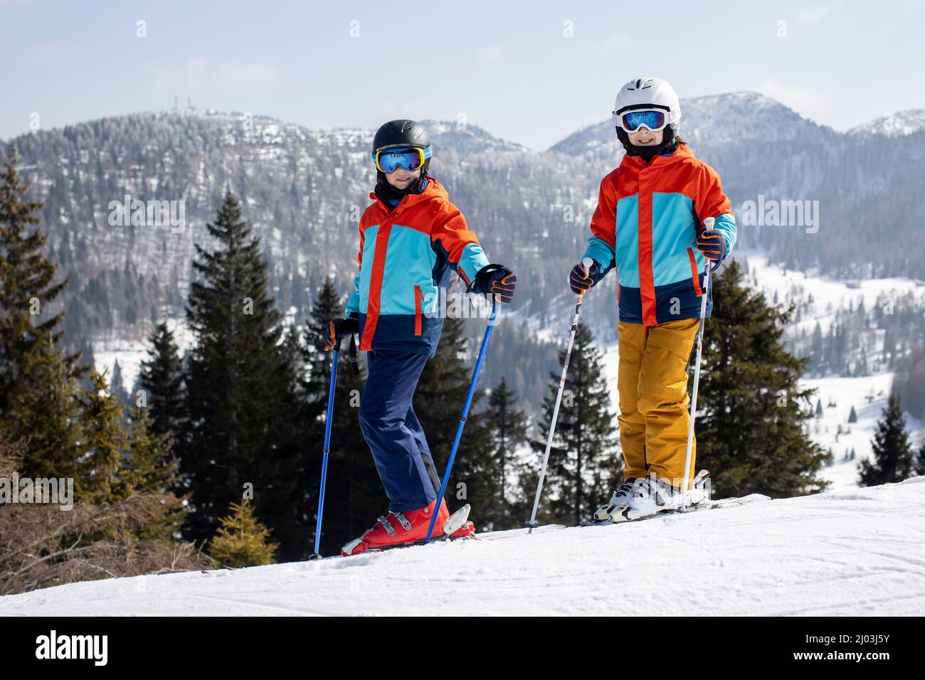 Happy family, skiing in Italy on a sunny day, kids and adults skiing ...