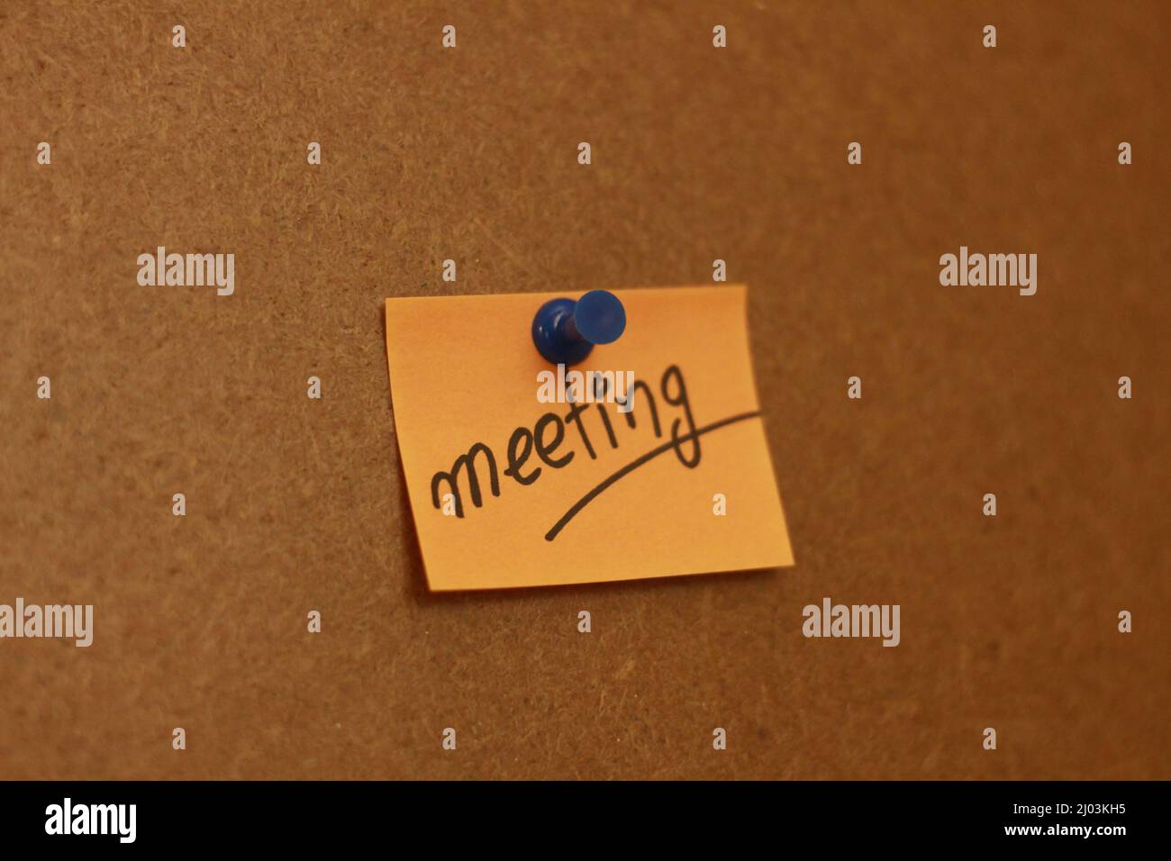 Meeting written on sticky note concept designed with woman hand Stock ...