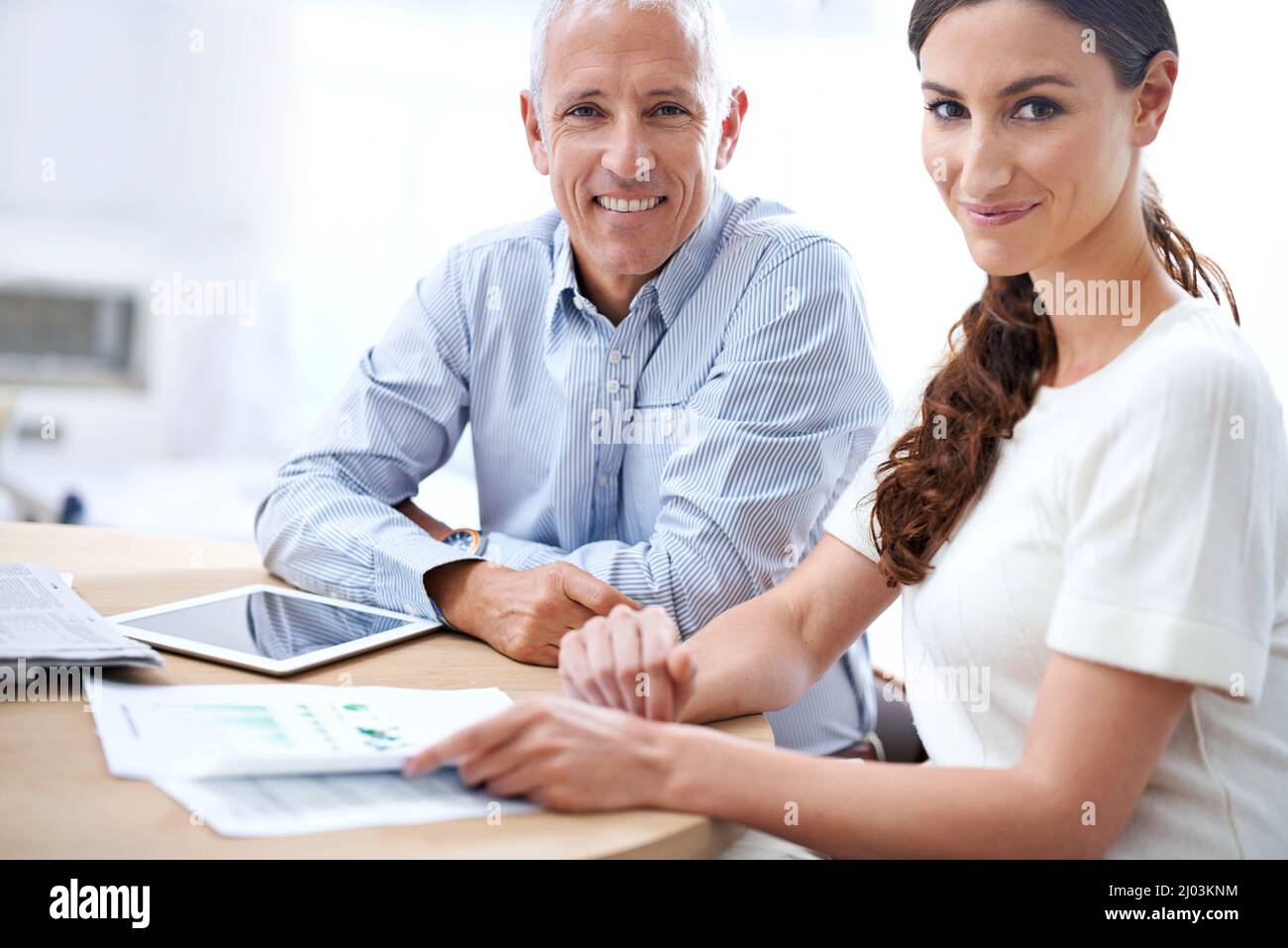 Getting the job done with a smile. Shot of two colleagues reading ...