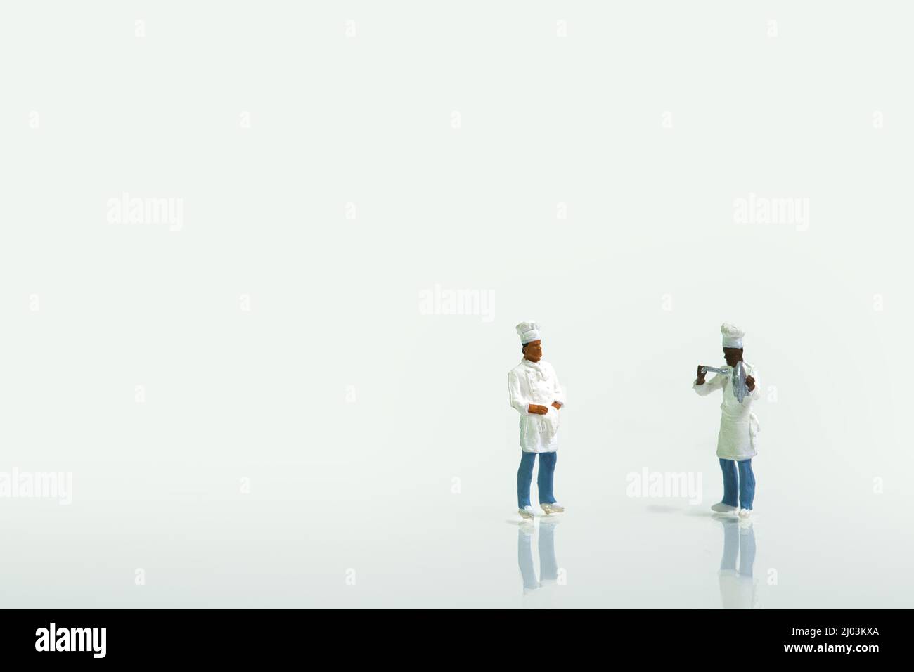 two cooks in work clothes isolated on white background Stock Photo - Alamy