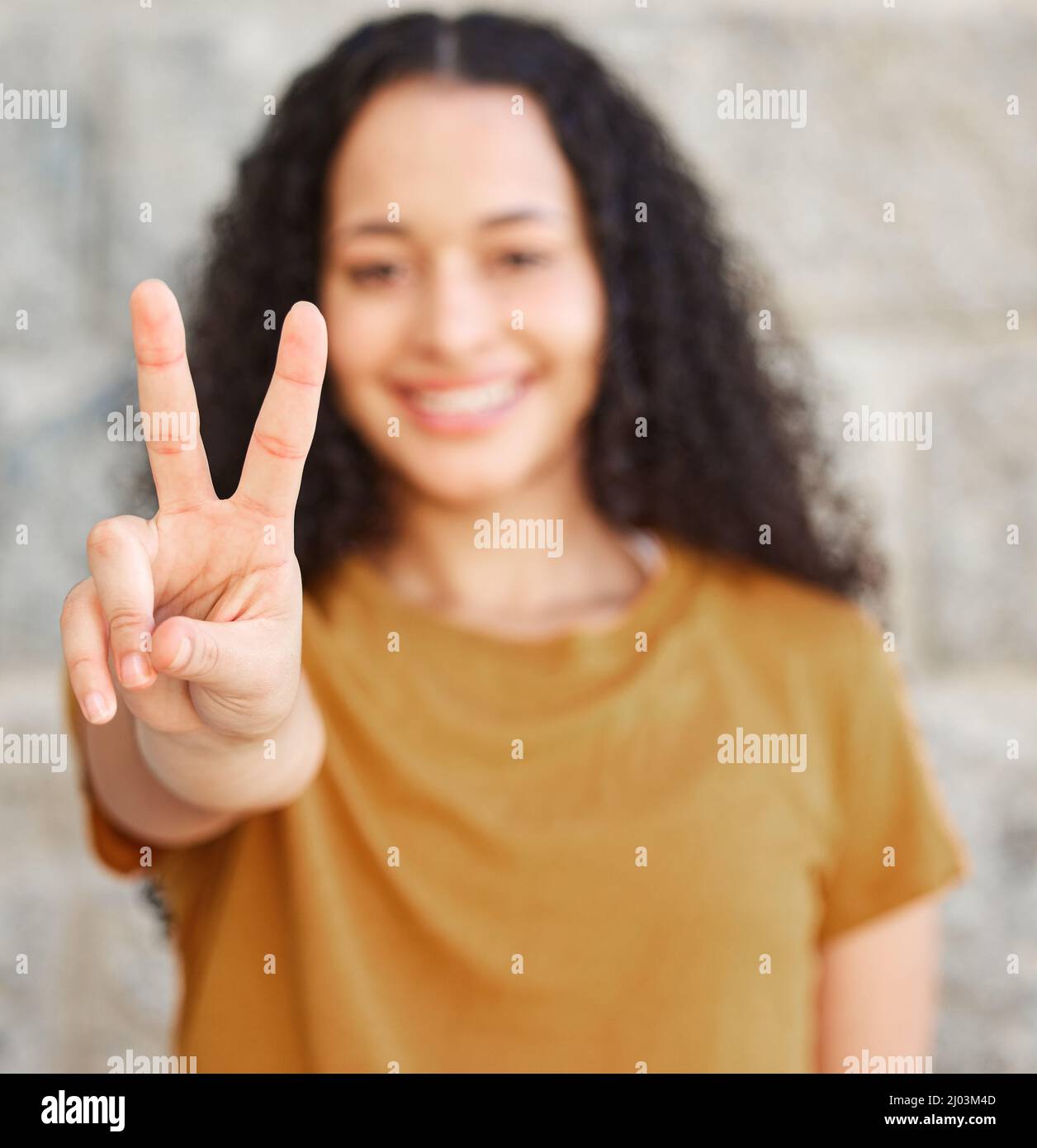 Lets make this world a peaceful one. Shot of a woman showing the peace ...
