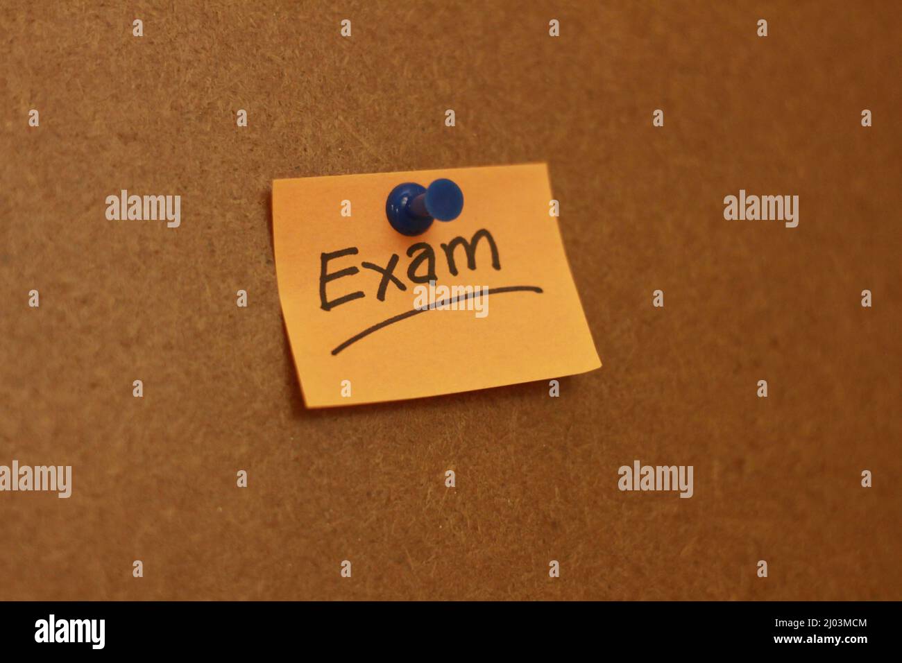 Exam text written on sticky note concept designed with woman hand Stock ...