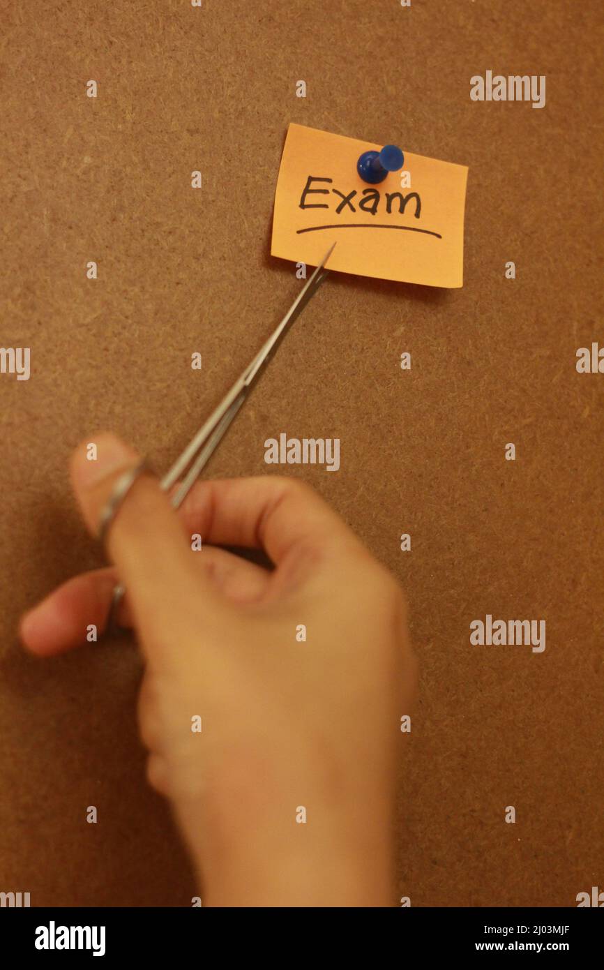 Exam text written on sticky note concept designed with woman hand Stock ...