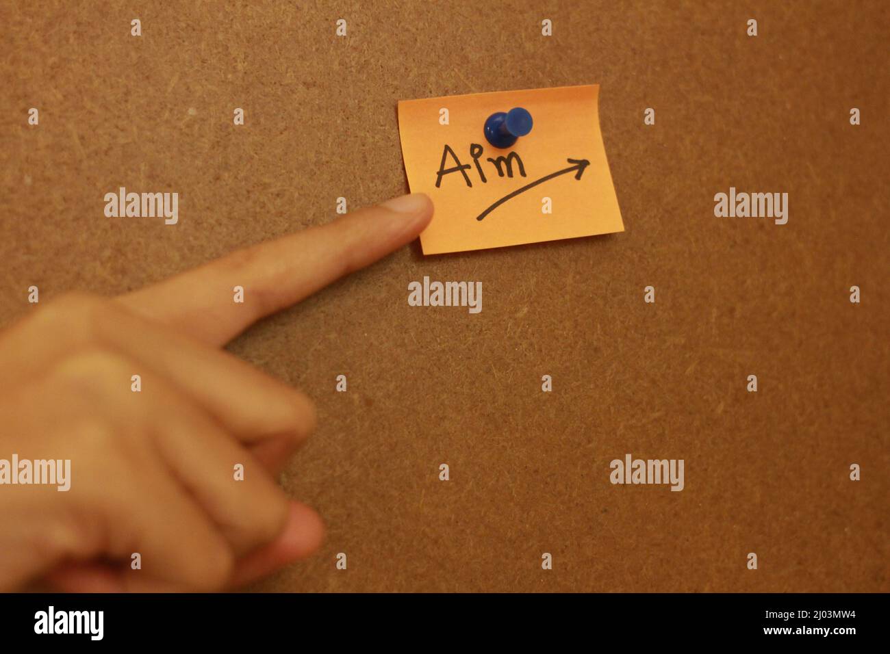Aim text written on sticky note concept designed with woman hand Stock ...