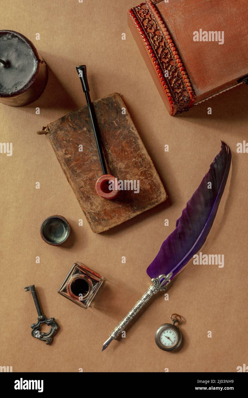 Vintage pipe, notebook, a quill pen, and a retro watch. Private ...