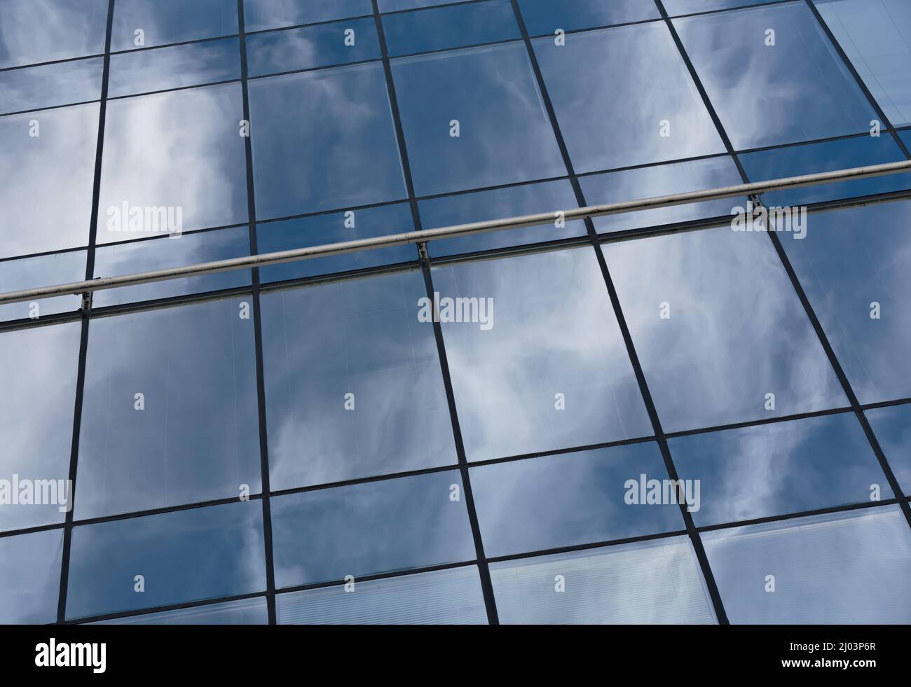Sky colors reflecting on a oblique glass wall Stock Photo - Alamy