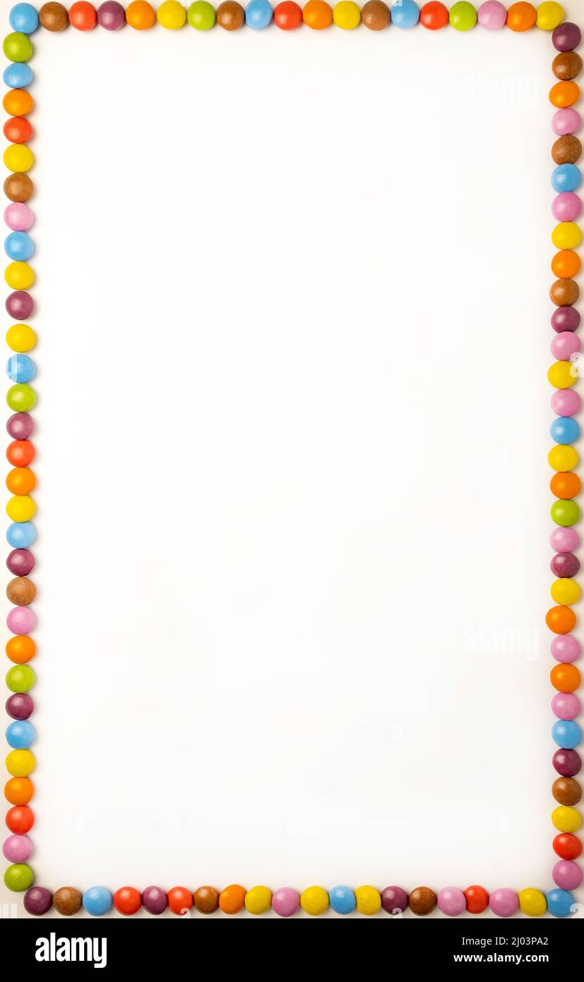 Small round rectangular candies laid out on the edge of the frame on a ...