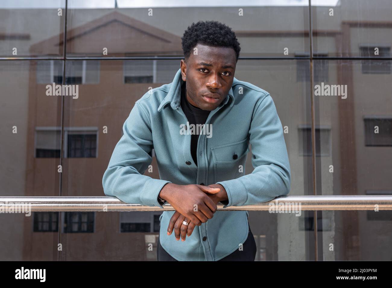 Man on railing hi-res stock photography and images - Alamy