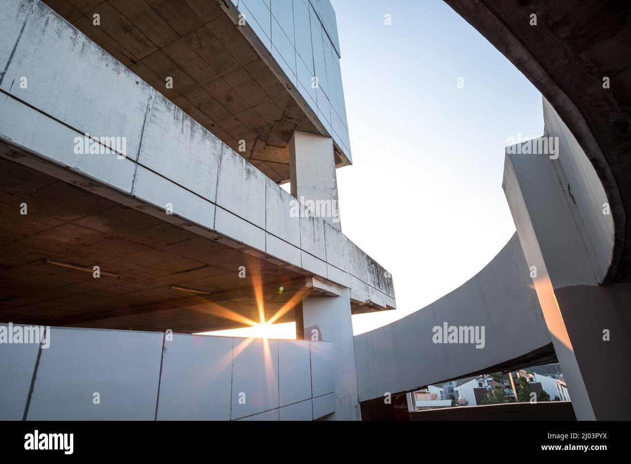 Perspective view of a circular car parking garage against the sun ...