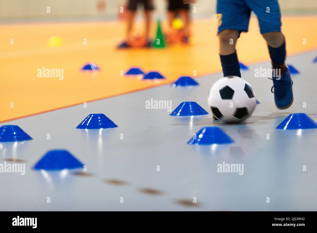 Boy in Soccer Clothes with Futsal Ball on Dribbling Drill. Kid on ...