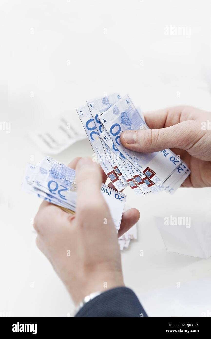 Vertical shot of a man's hand counting money isolated on a white ...