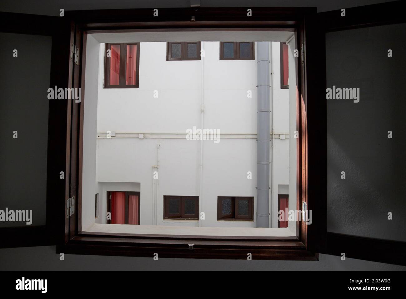 double window opening up into central atrium of a building to keep cool ...