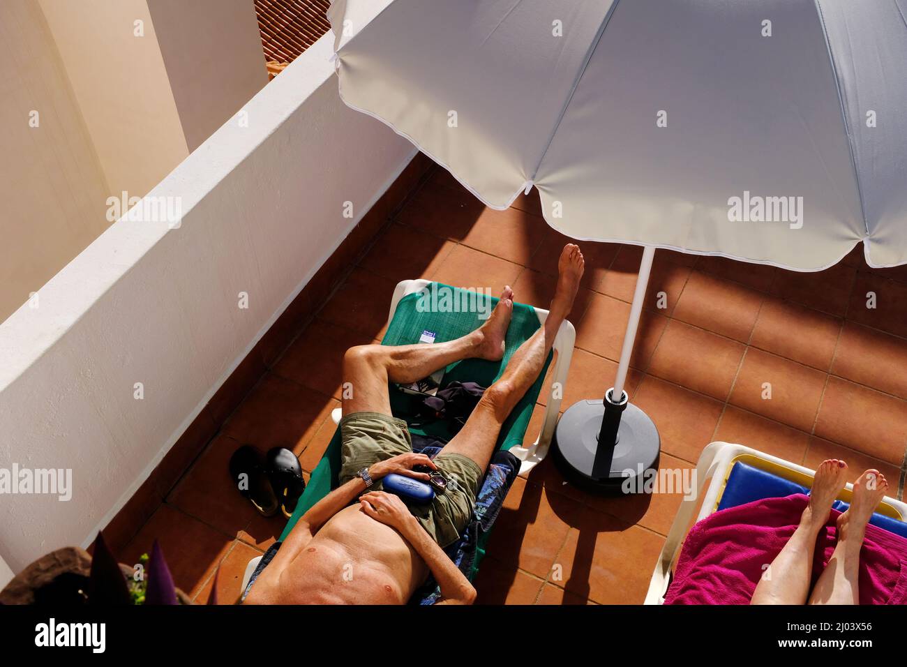 Pairs of legs sunbathing Stock Photo - Alamy