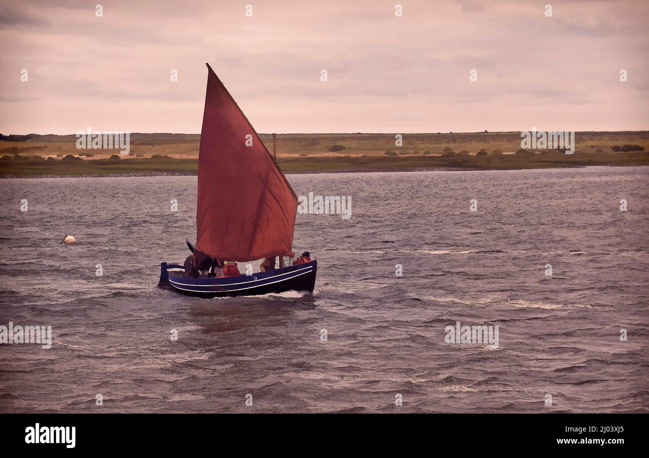 Small sailing boat travelling up the river channel heading for Wells ...