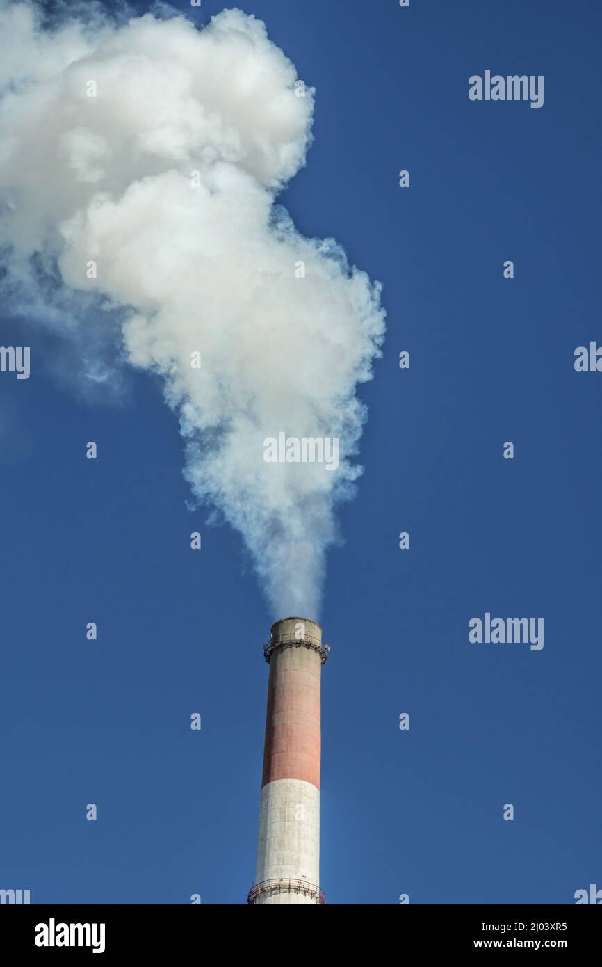 Powerful industrial factory chimney is smoking and emitting carbon ...