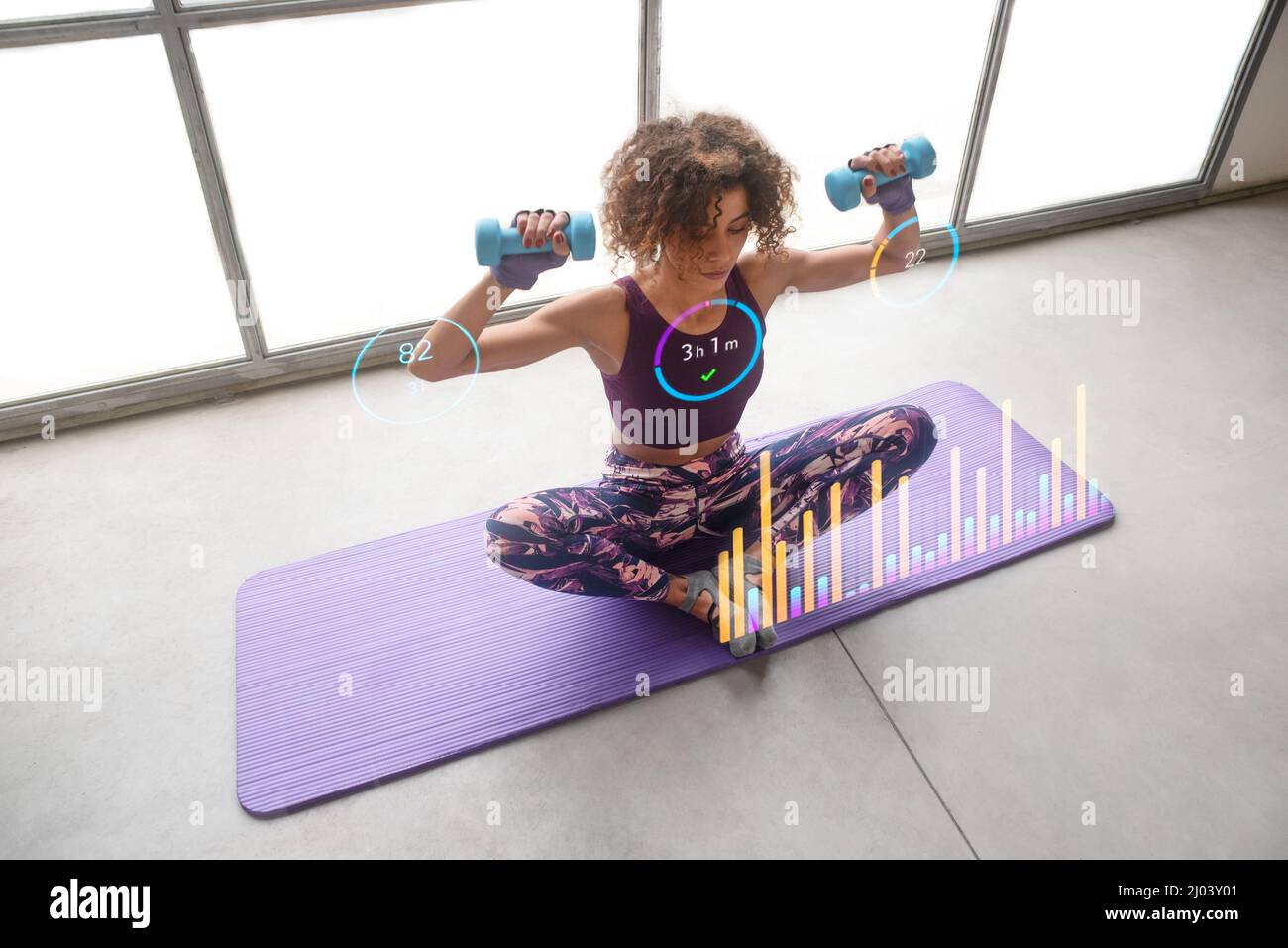Young beautiful woman doing exercise on a mat with dumbells on the ...