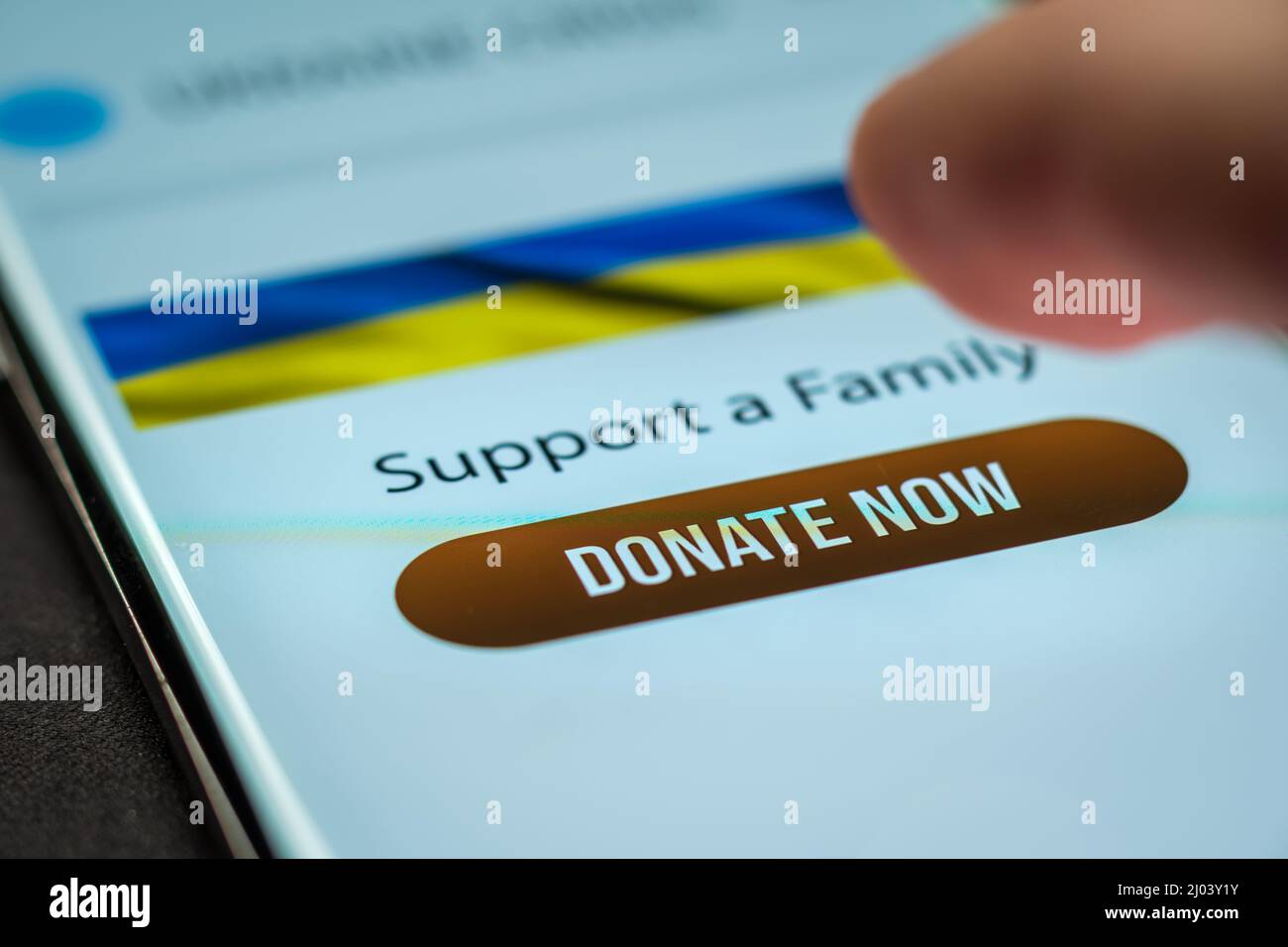 Close-up finger pressing donate button on smartphone screen. Donation ...