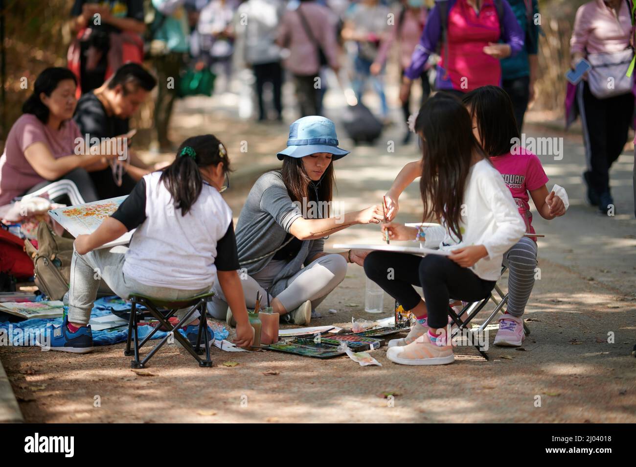 Women and girls are drawing watercolor under tree shadow in Tai Tong ...