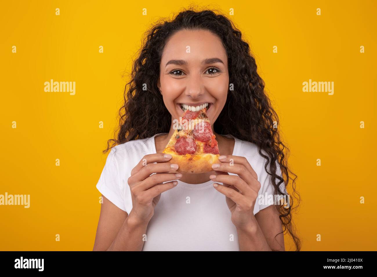 Young woman eating pizza model hi-res stock photography and images - Alamy