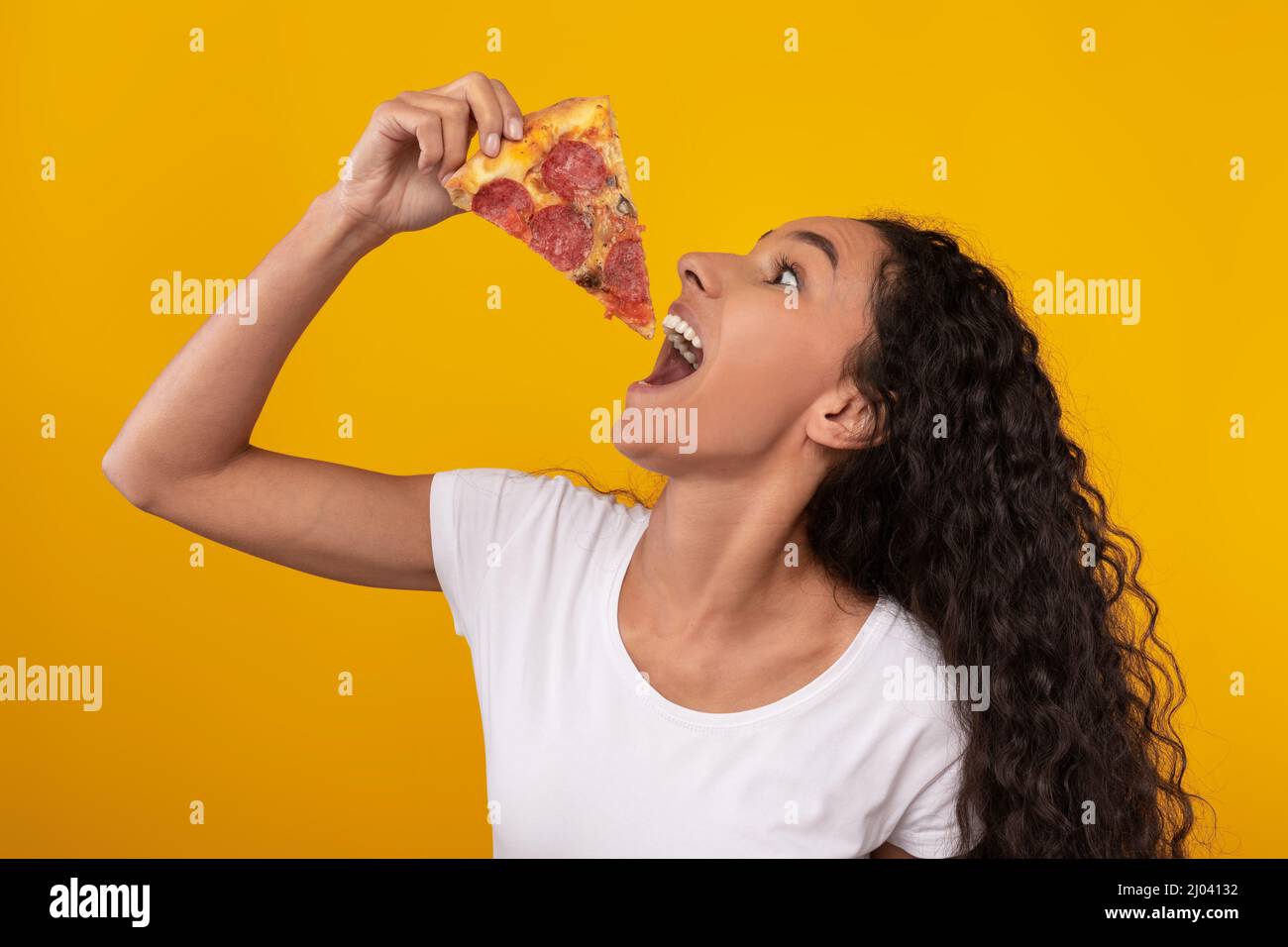 Young woman holding pizza model hi-res stock photography and images - Alamy