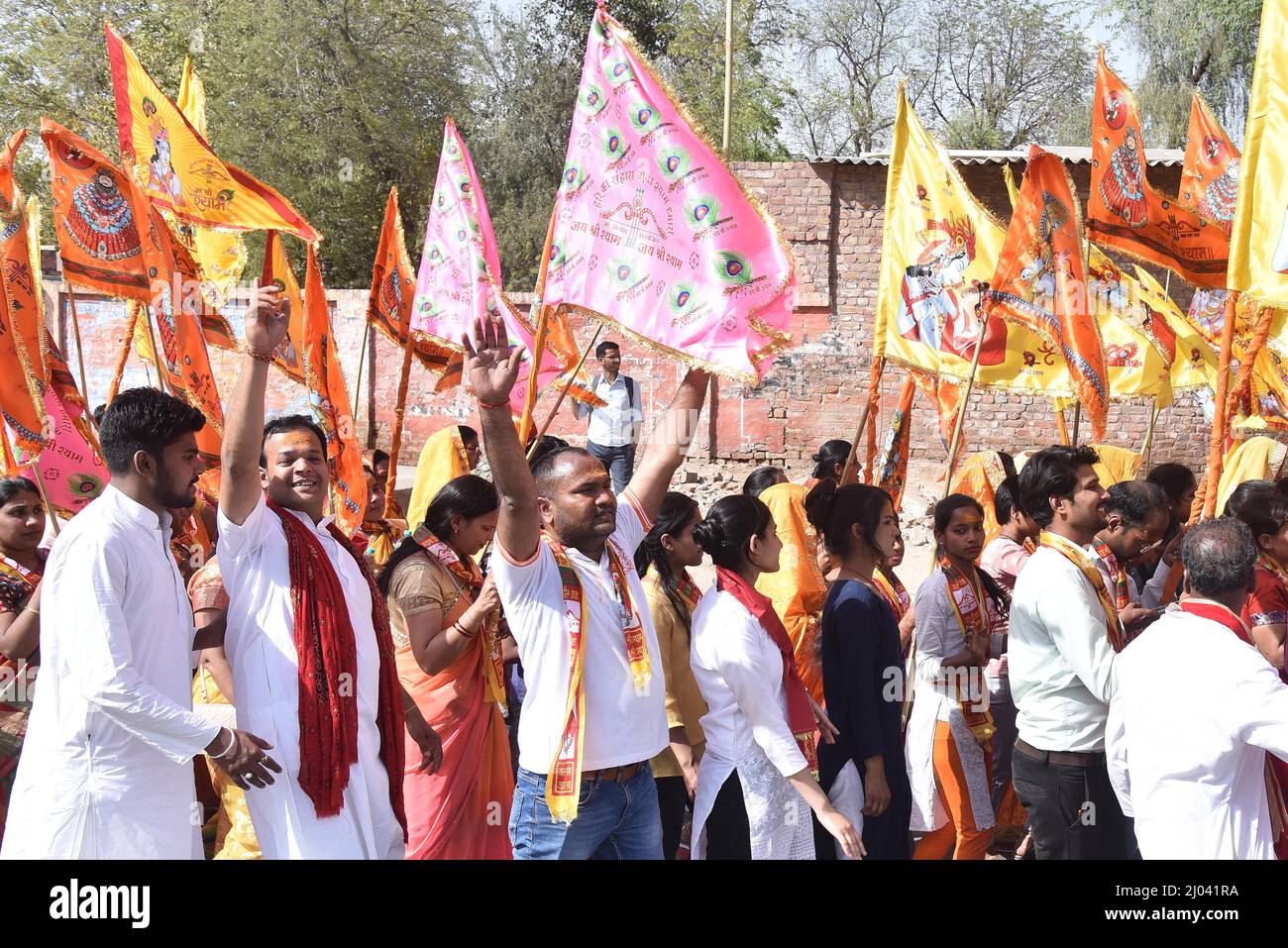 Bikaner, India. 15th Mar, 2022. Devotees dancing, carrying yellow flags ...