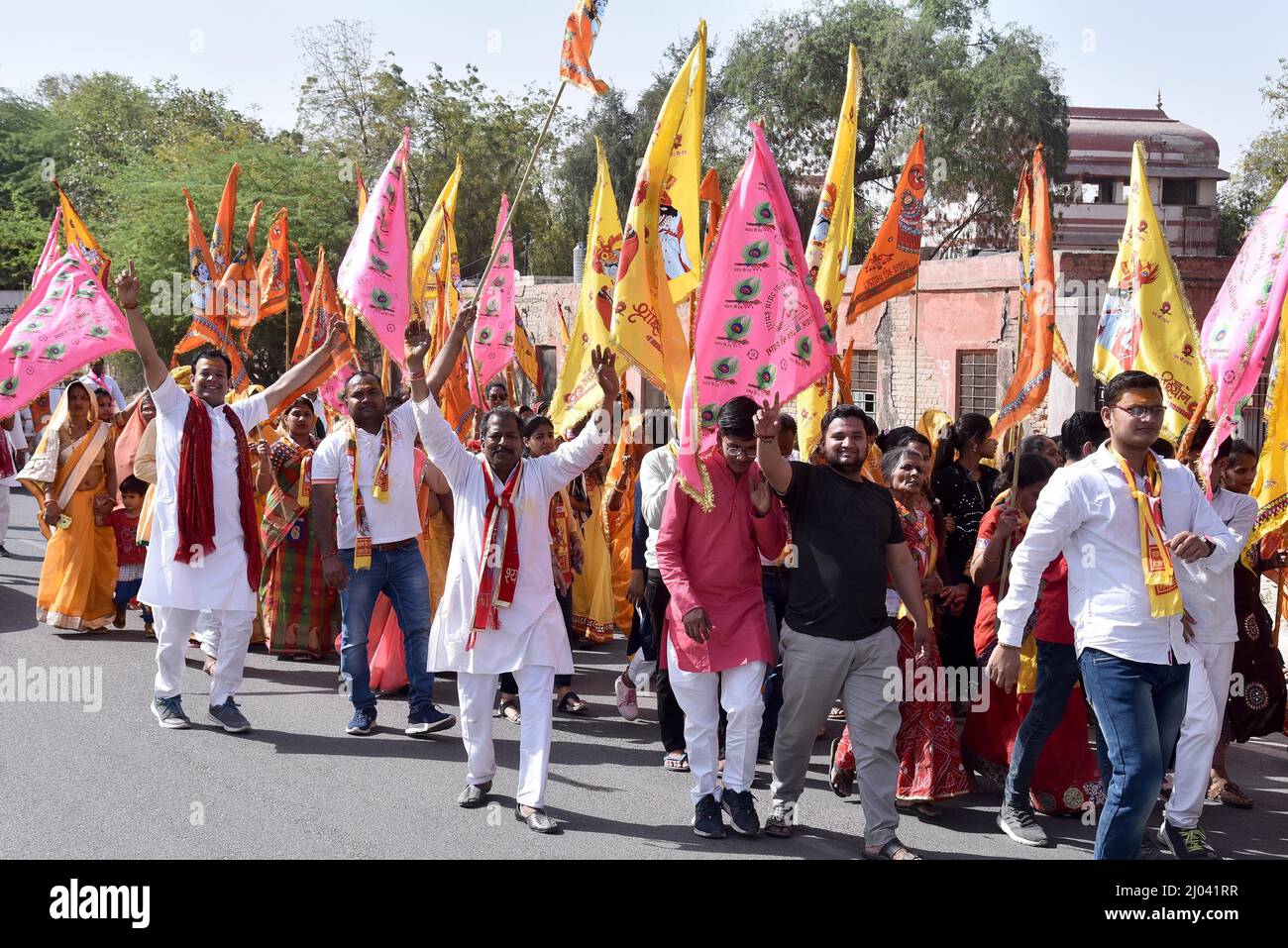 Bikaner, India. 15th Mar, 2022. Devotees dancing, carrying yellow flags ...