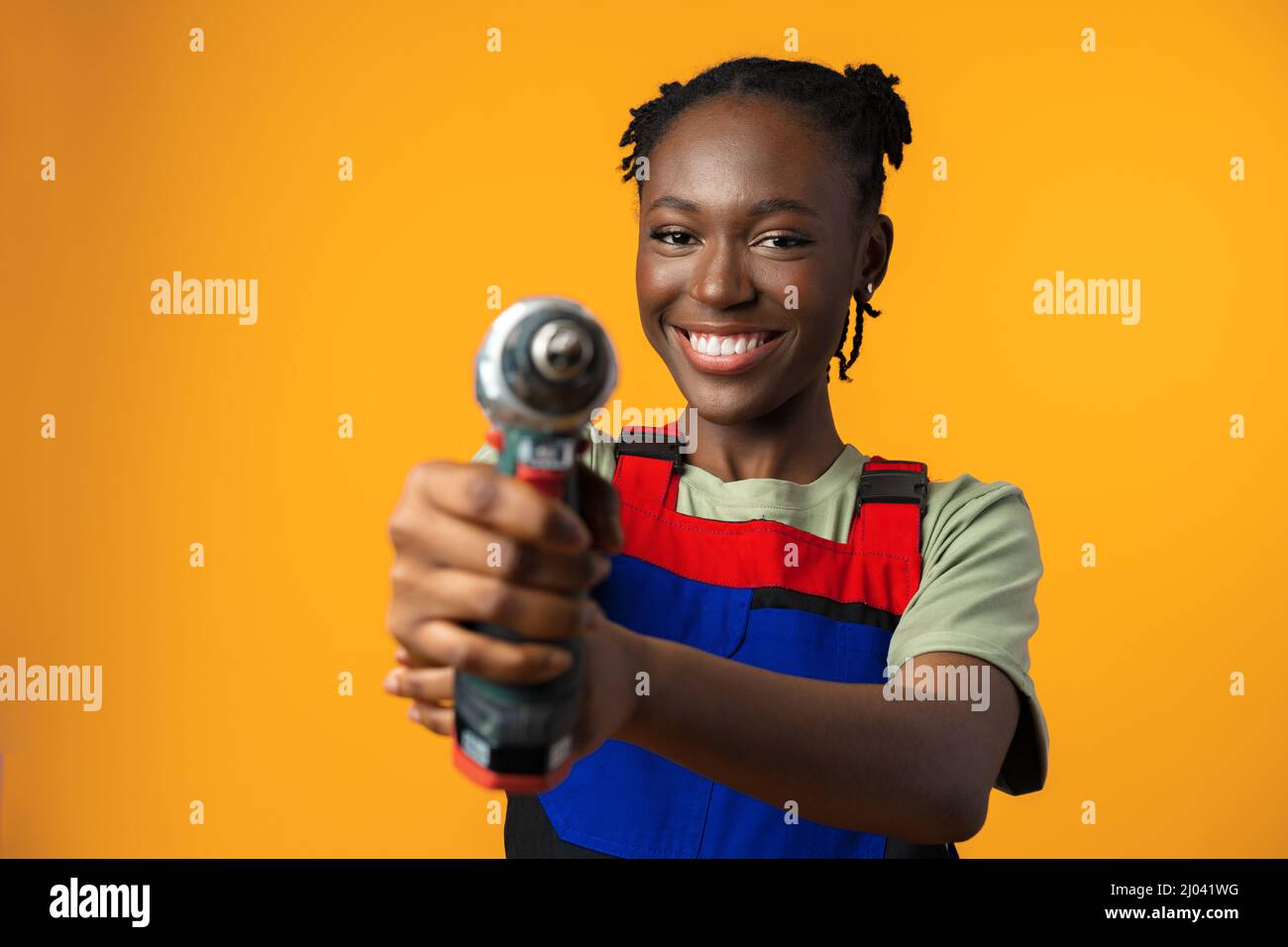 Black African American female model in uniform holding a screwdriver ...