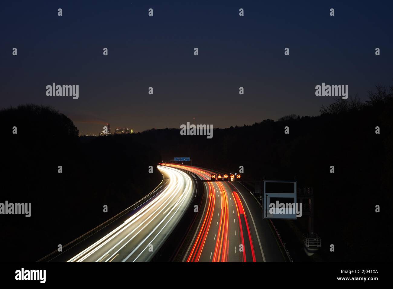 Long exposure shot of a highway illuminated with traffic lights in the ...