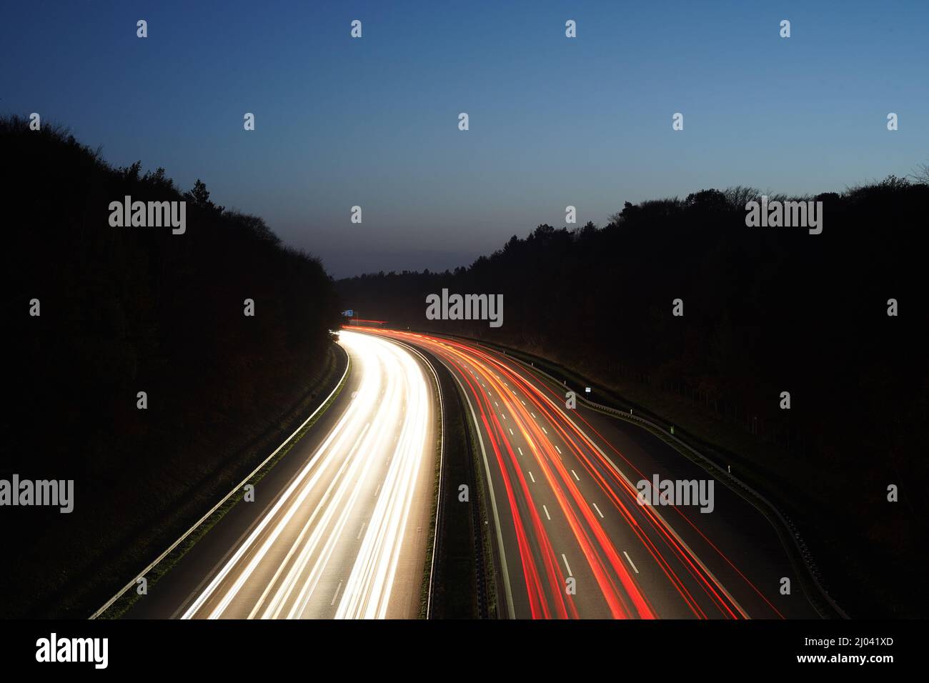 Long exposure shot of a highway illuminated with traffic lights in the ...