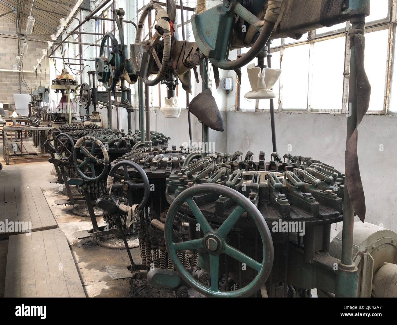 Shot of the old machines in an ancient hats factory during daytime ...