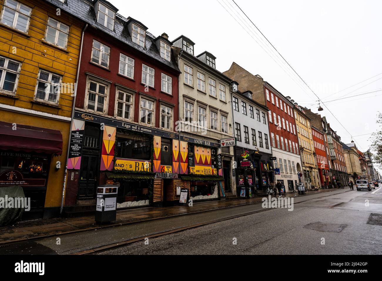 Beautiful shot of cars driving in the streets between colorful ...