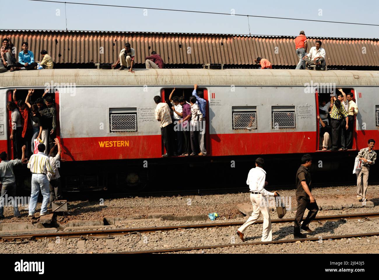 Indian commuters travel on the roof of a train performing stunts on ...