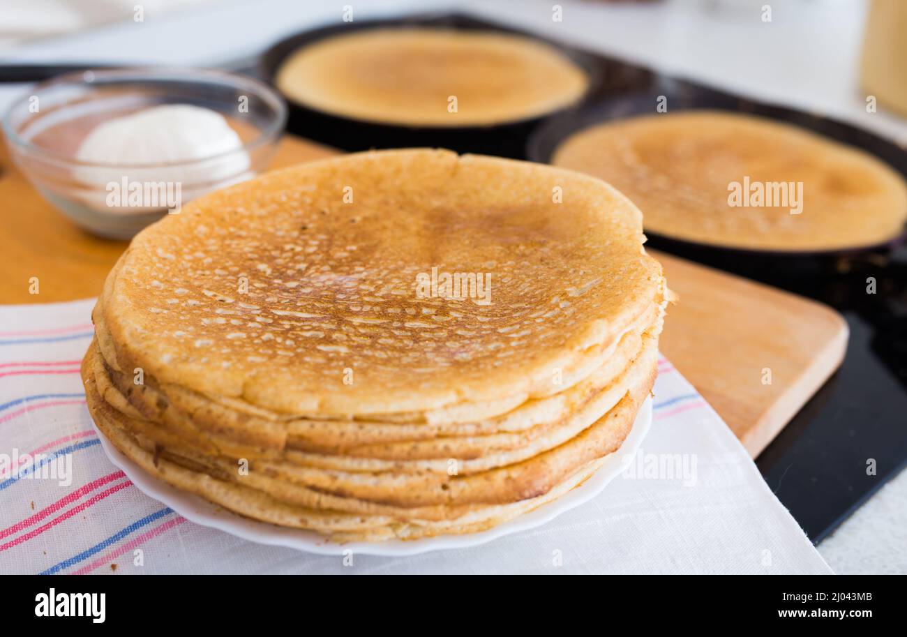 stack of appetizing flour pancakes in the kitchen during cooking Stock ...