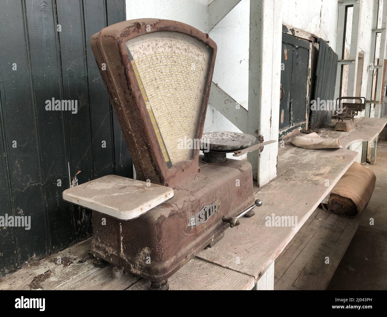 An old rusty scale on a shelf against black and white wall in an ...