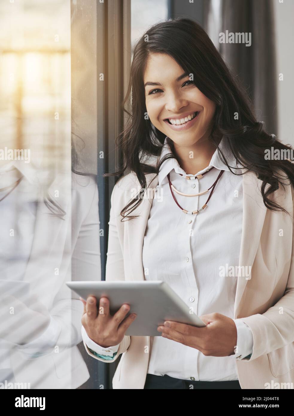 My digital assistant keeps me organized. Shot of a young businesswoman ...
