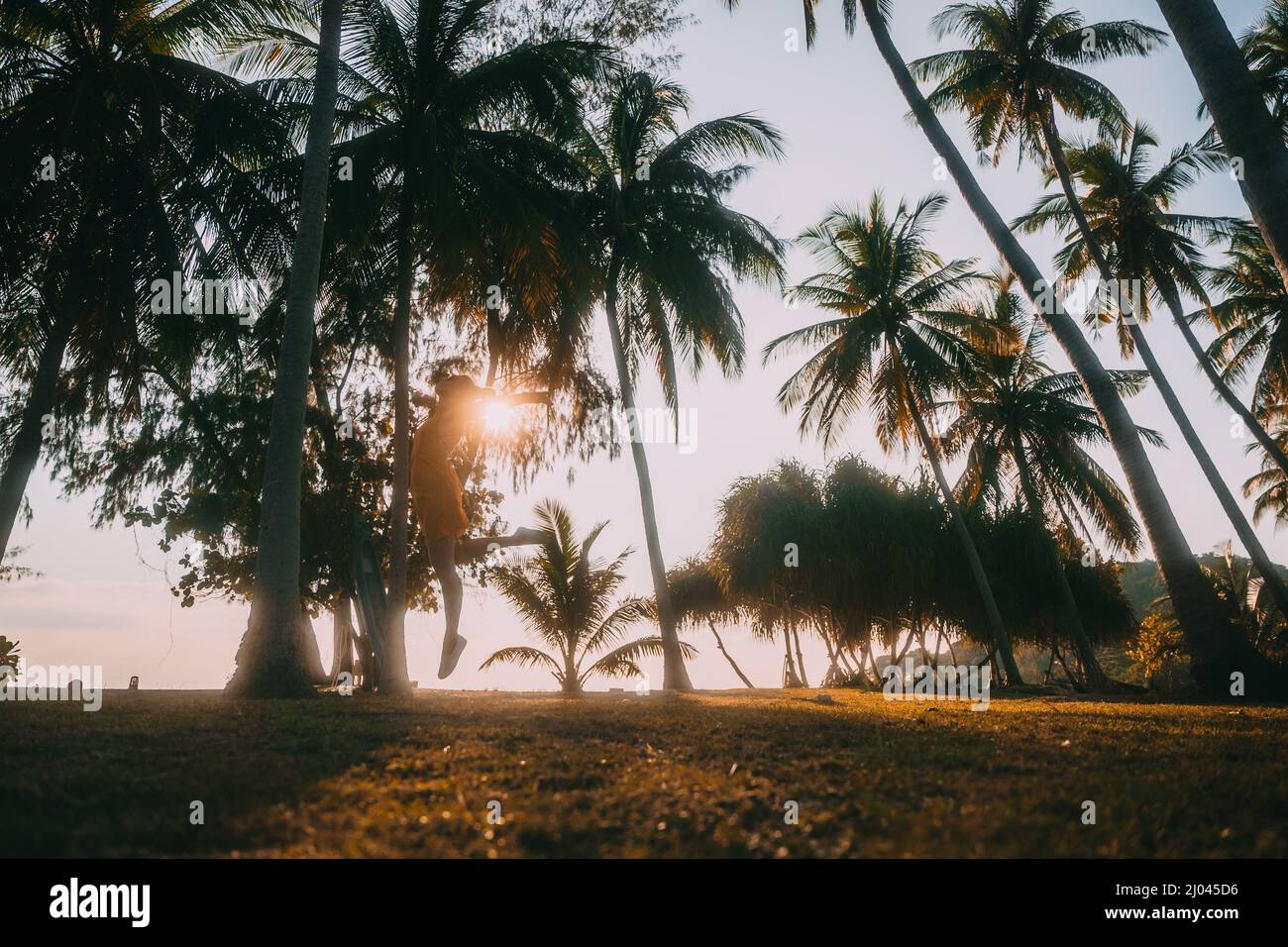 Beautiful shot of a Polish girl in front of green palms during the ...