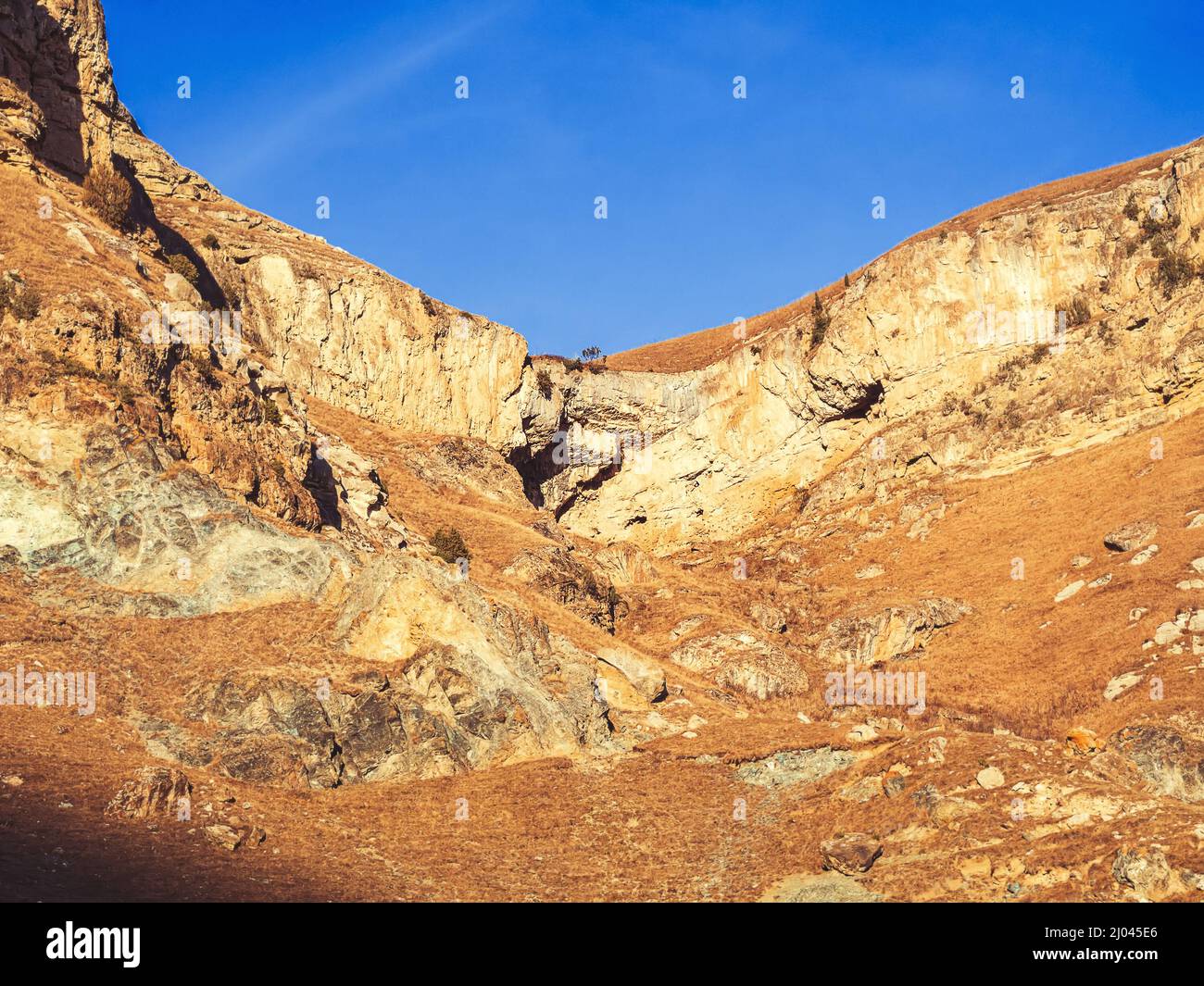 Autumn rocky plateau illuminated by the sun against blue sky. Country ...