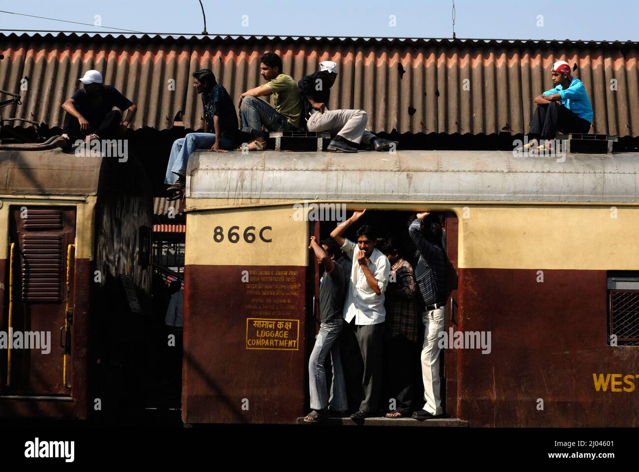 Indian commuters travel on the roof of a train performing stunts on ...